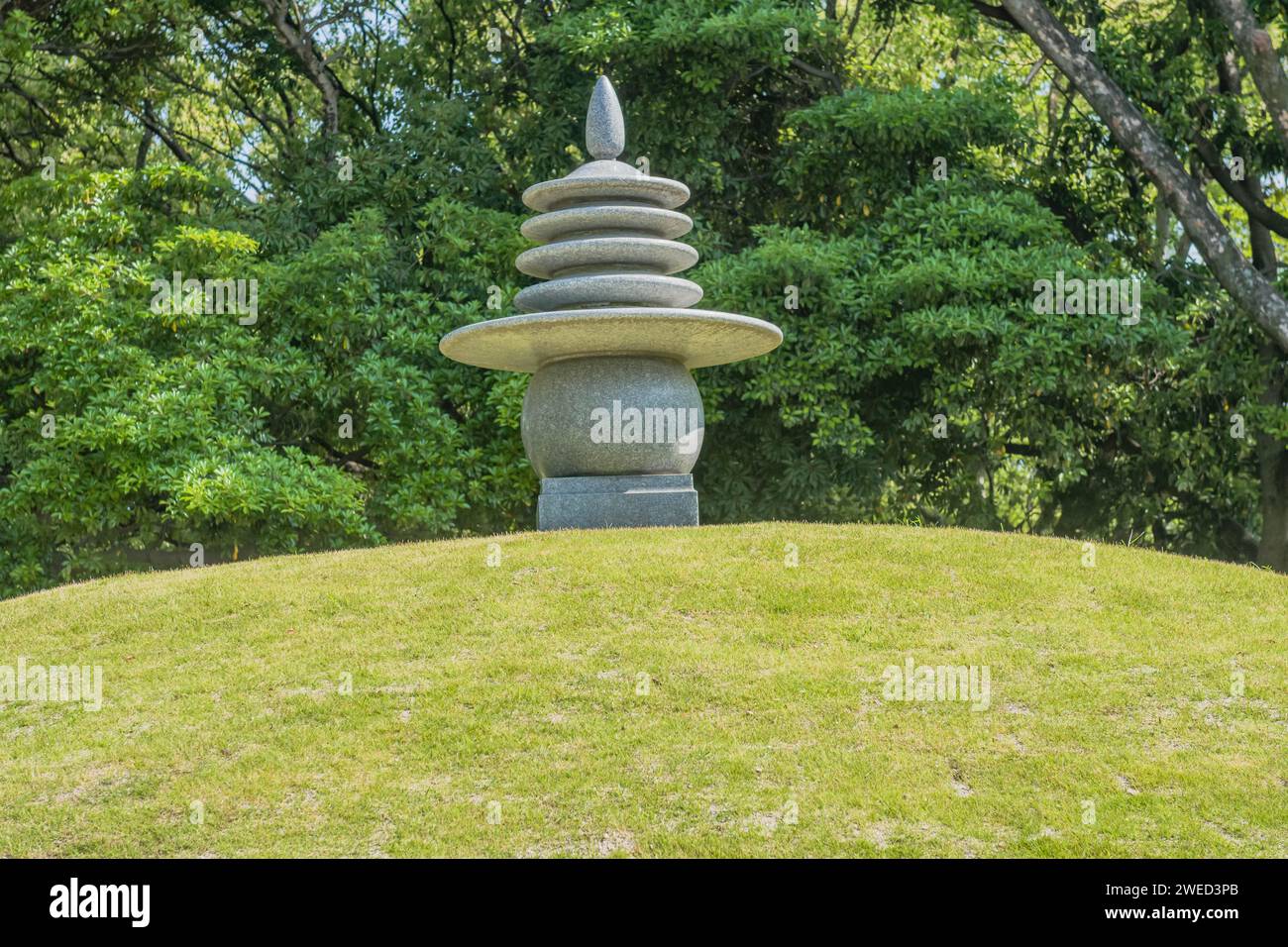 Round stone carved pagoda on hilltop in Hiroshima Peace Park in ...