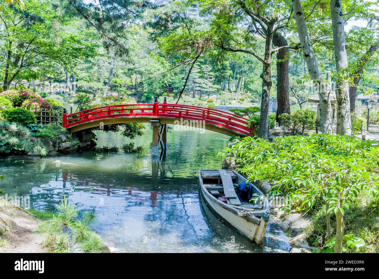 Wooden row boat at shore of lake in Japanese Shukkeien Gardens in ...