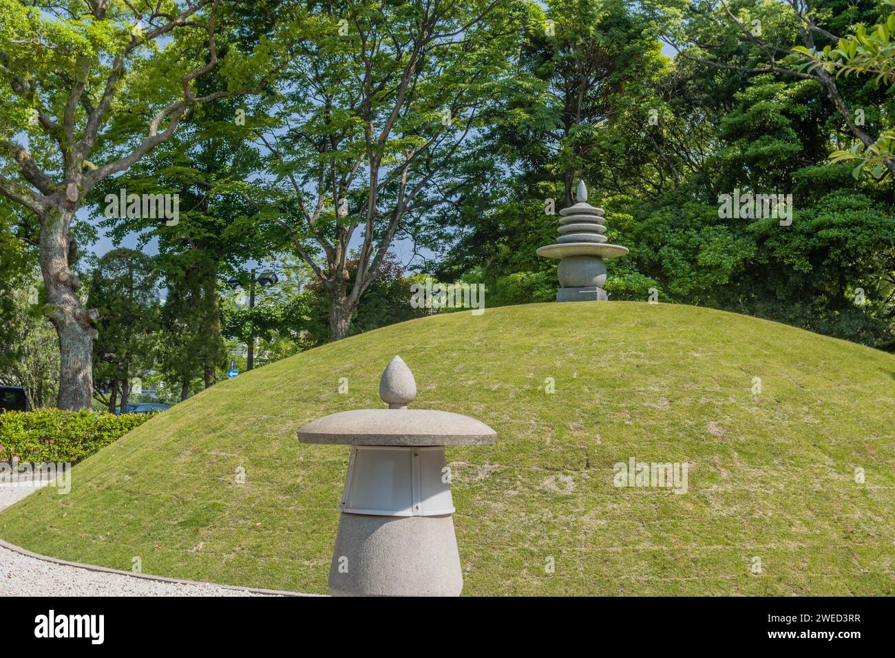 Round stone carved pagoda on hilltop in Hiroshima Peace Park in ...