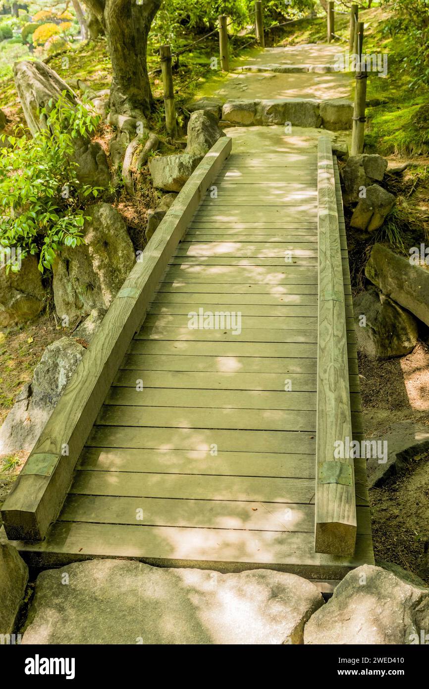 Shaded wooden footbridge in Japanese Shukkeien Gardens in Hiroshima ...
