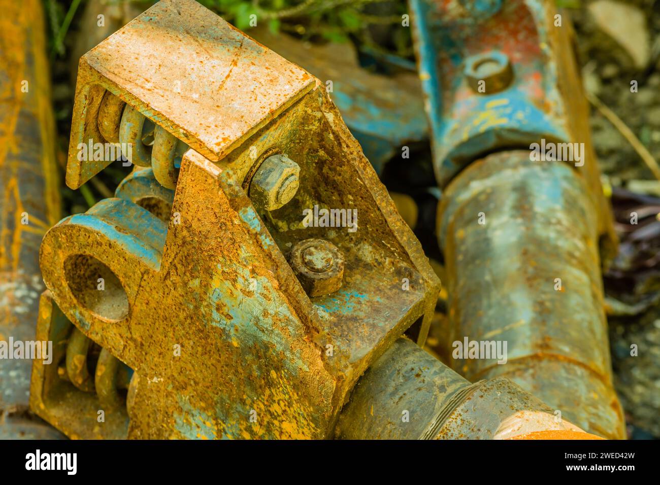 Closeup of rusted metal industrial machine parts discarded and laying ...