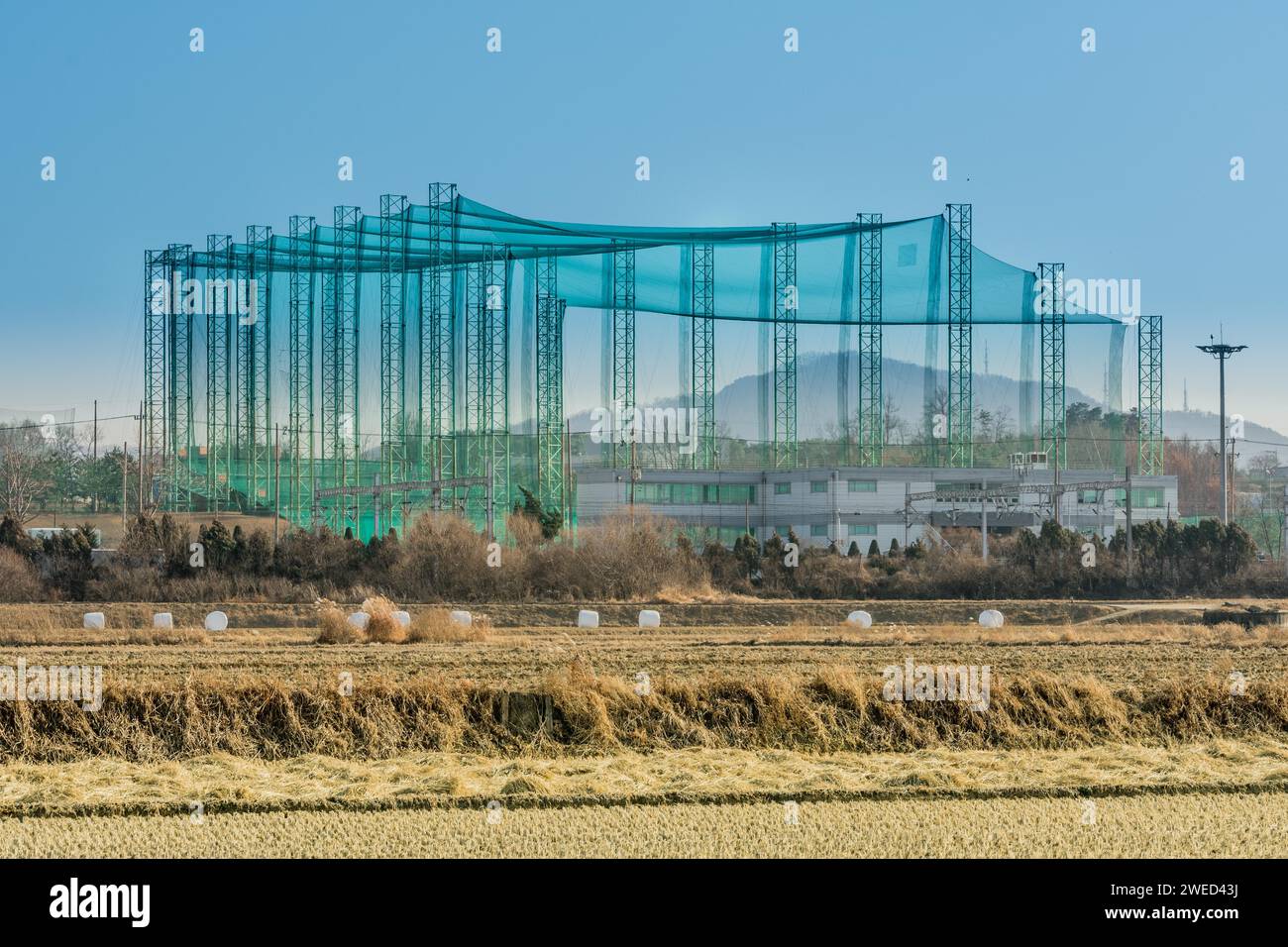 Golf driving range constructed of metal trussed columns and green ...