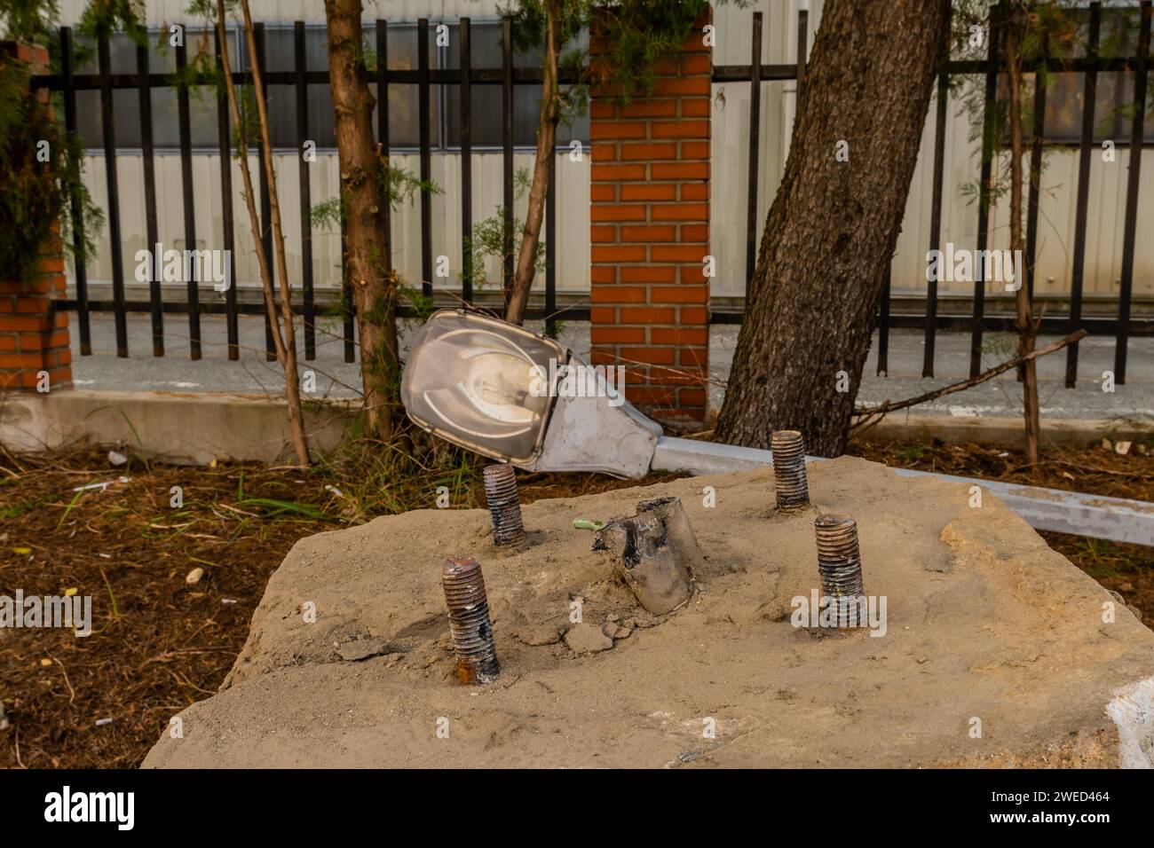 Old dismantled streetlight removed from lamppost and laying on ground ...