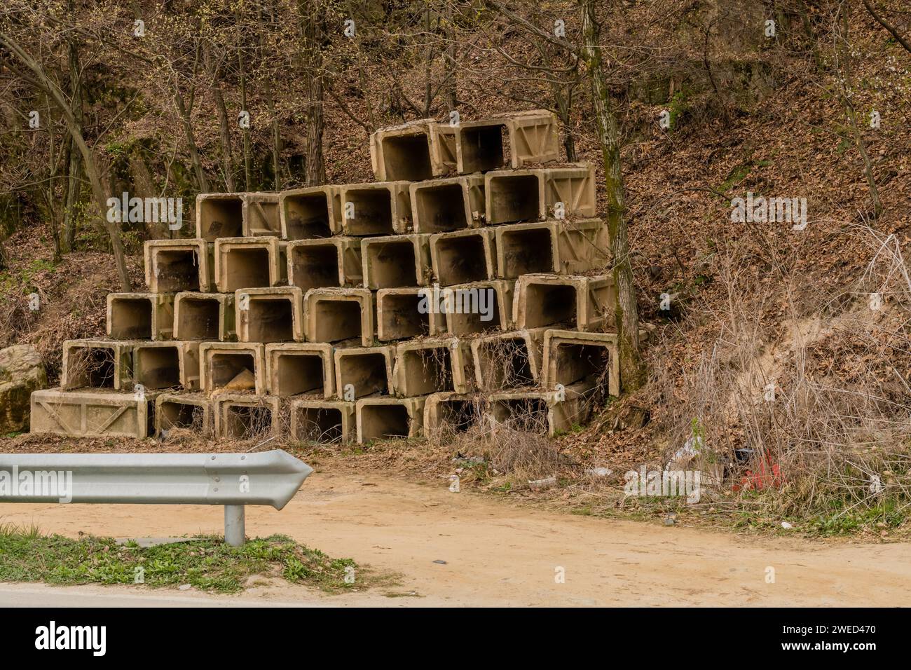 Square concrete culverts stacked in rows beside dirt road Stock Photo ...