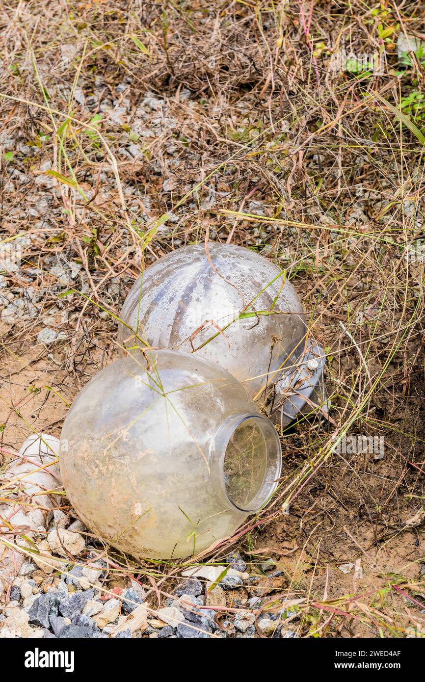 Two round glass light covers laying outside on ground Stock Photo - Alamy