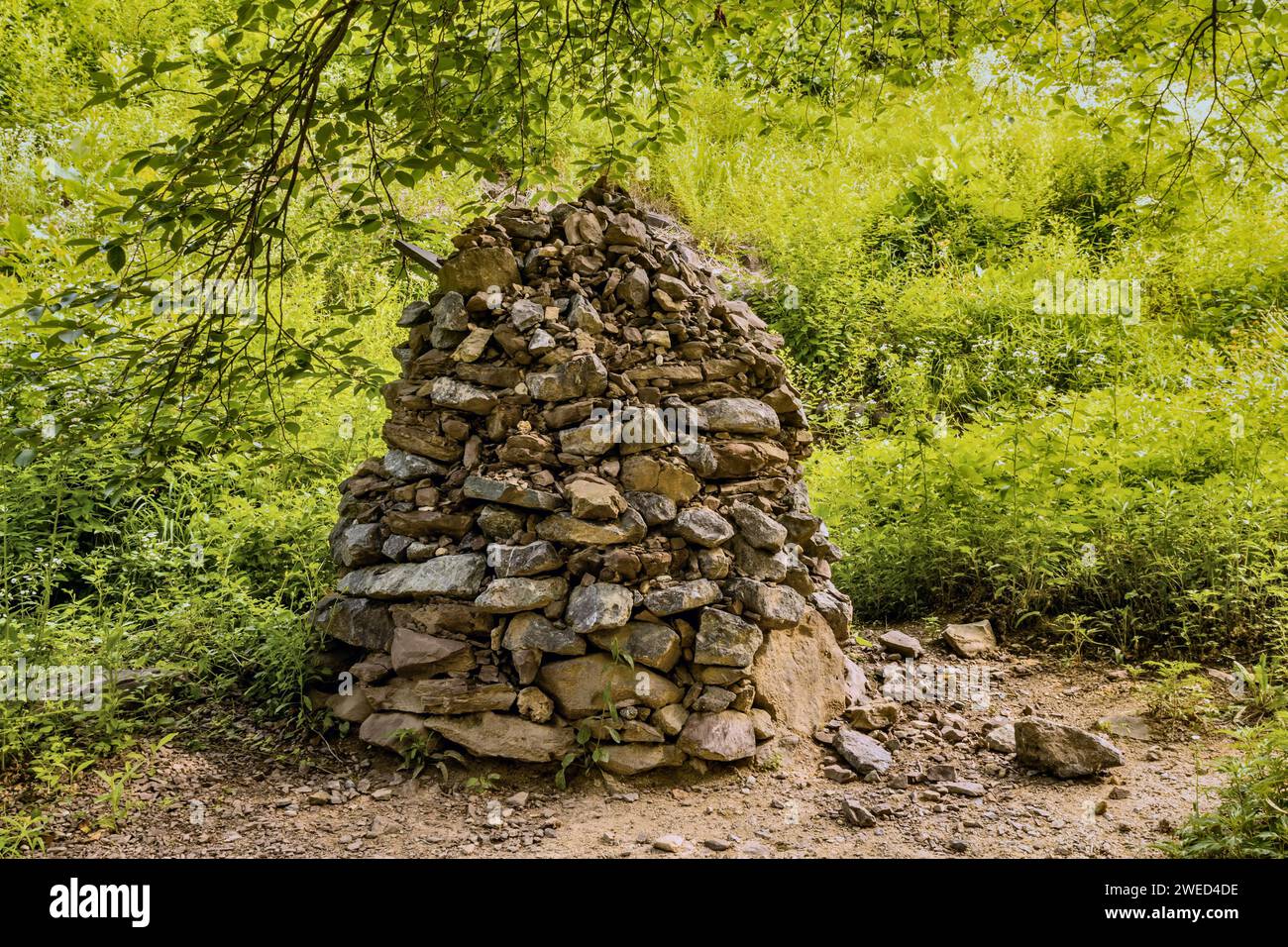 Column of stones and pebble stacks beside hiking trail in recreational ...