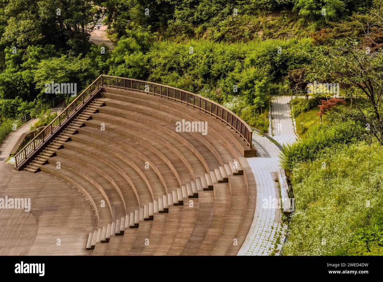 Wooden arena style seating and deck on hiking trail in recreational ...