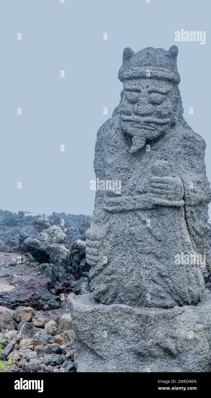 Ancient stone carved figure of sea god on coast of Jeju island, South ...