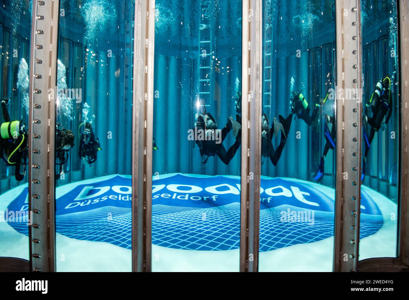 Close-up of several divers in the water in diving tower of Messe boot ...