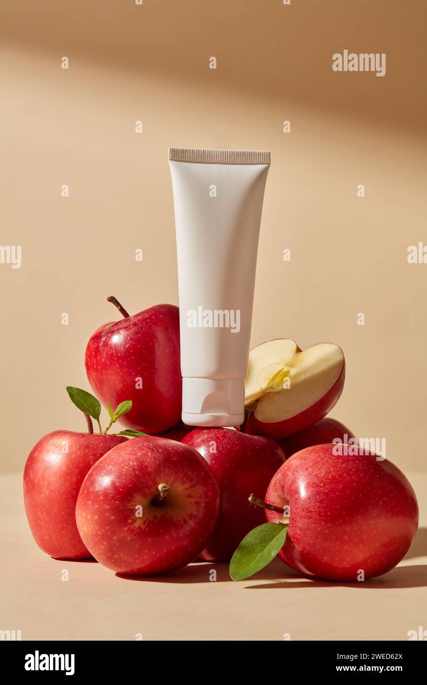 A stack of many apples with unlabeled white tube place on top ...
