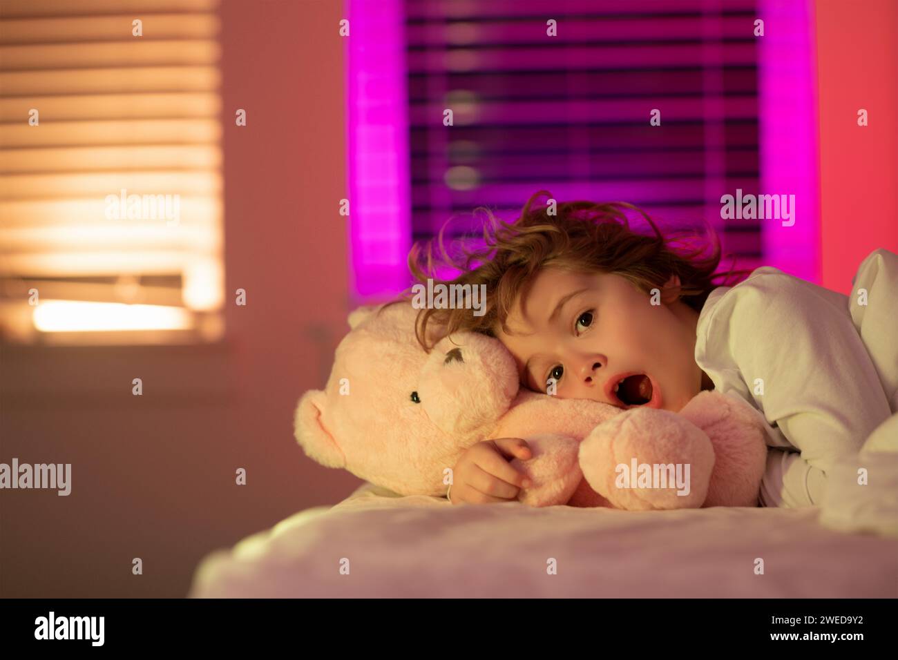 Cute drowsy sleepy child with toy teddy bear in bed, bedtime, childhood ...