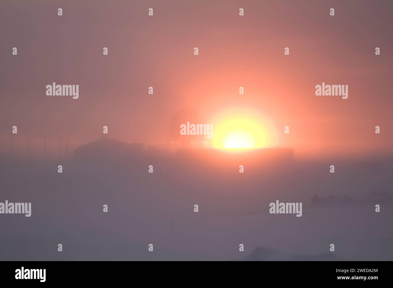 Sun sets as a blizzard freezes the landscape outside the Inupiaq ...