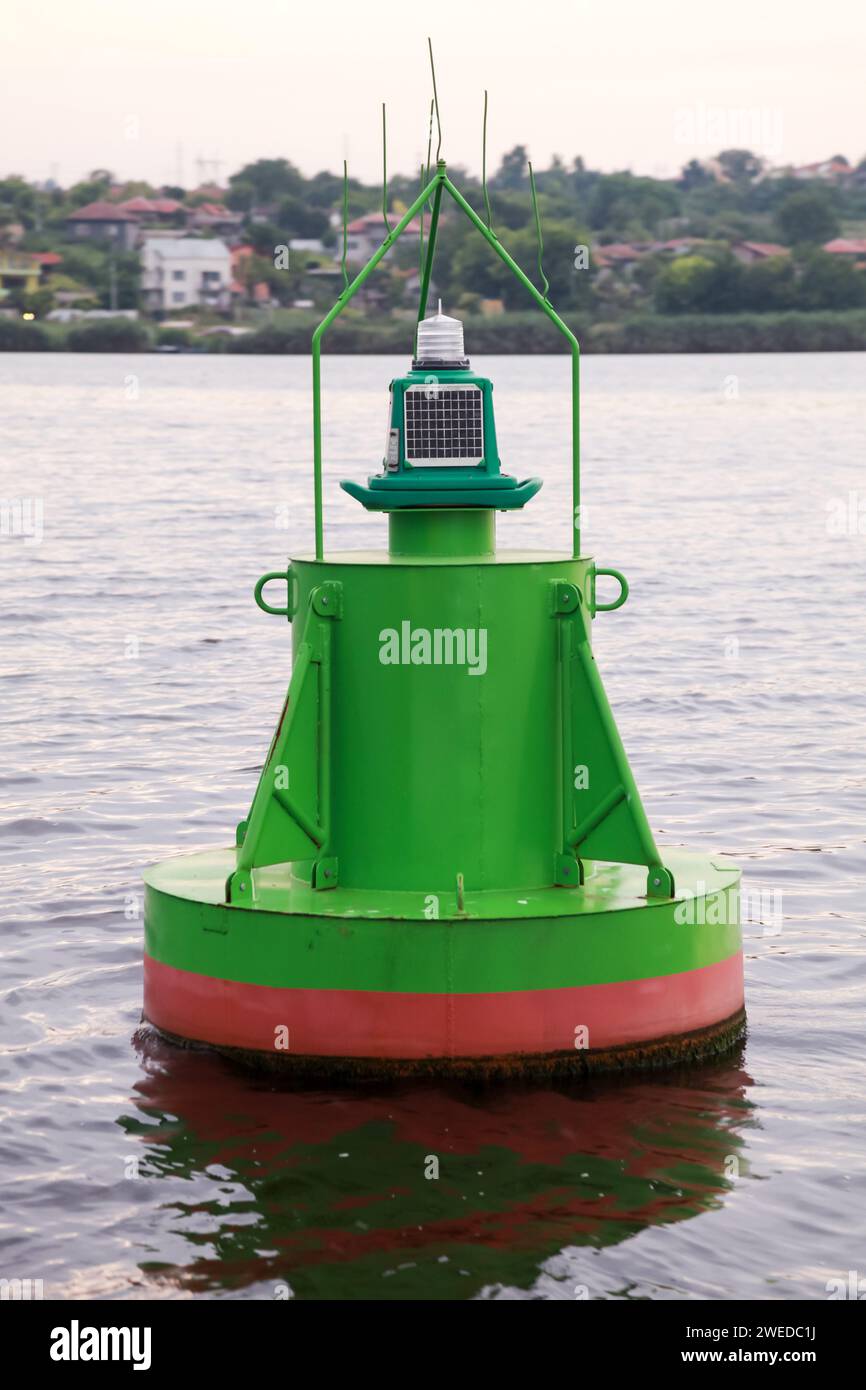 Green navigation buoy floating on sea water. Vertical photo. Varna ...