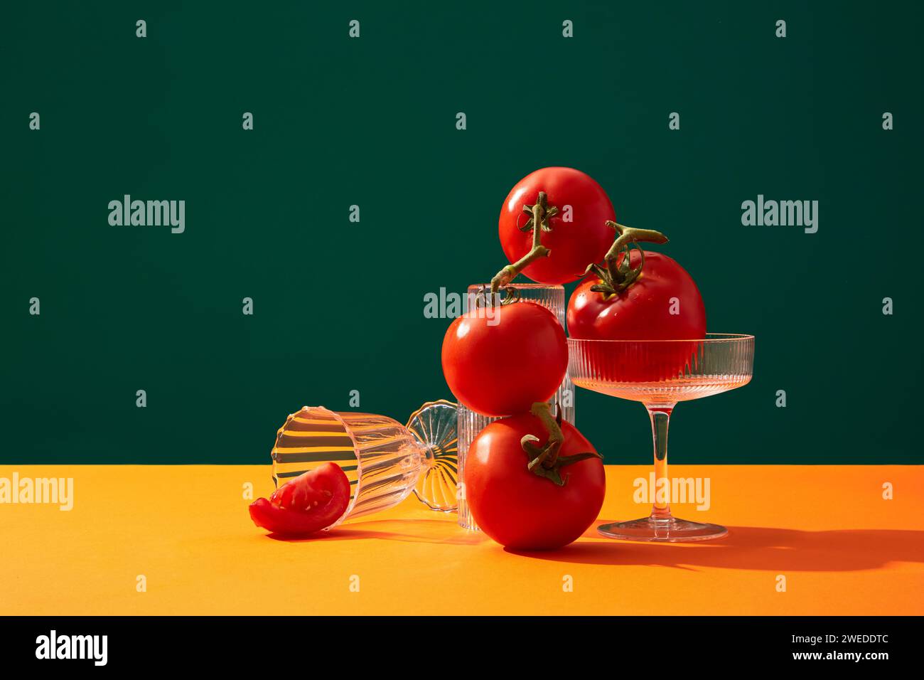 Luxury composition of fresh tomatoes with glasses in various shapes ...