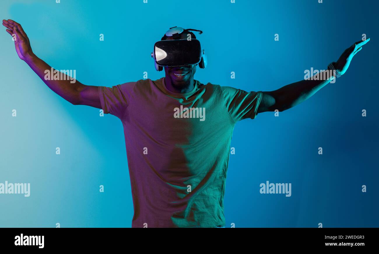 African American man dons VR glasses, engrossed in a virtual reality ...