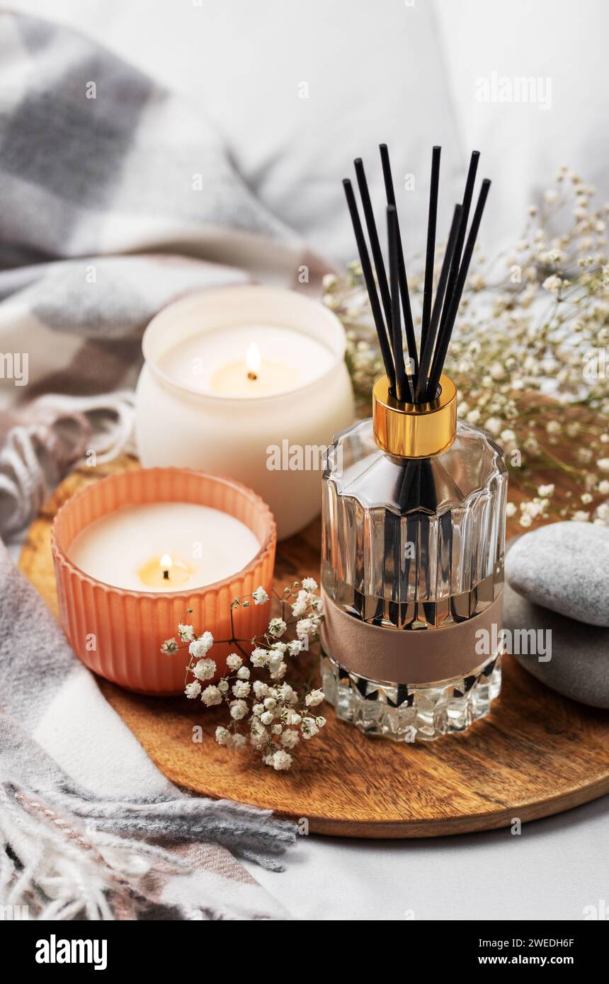 Cozy home atmosphere. Home liquid fragrance in glass bottle and scented ...