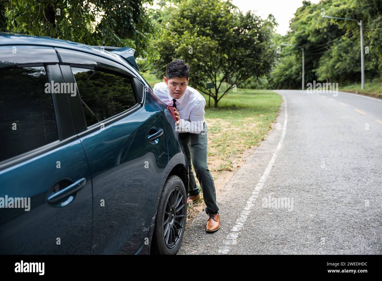 Asian businessman car broken has problems with car down during go to ...
