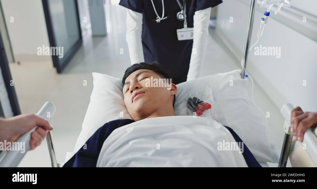 Asian man, patient and push bed in hospital for surgery, emergency or ...