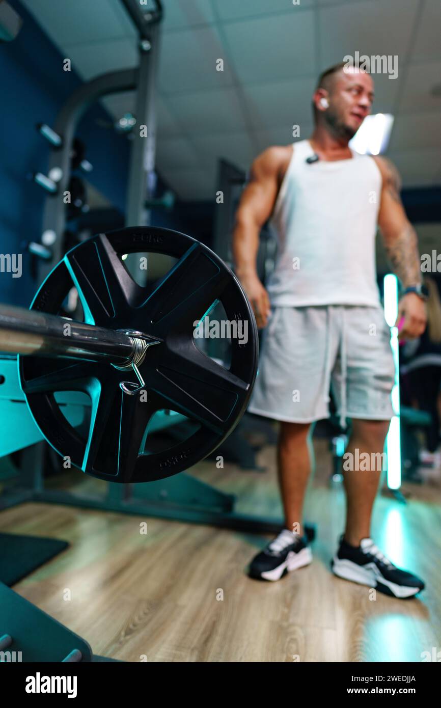 Man bodybuilder in white shirt training in a gym Stock Photo - Alamy