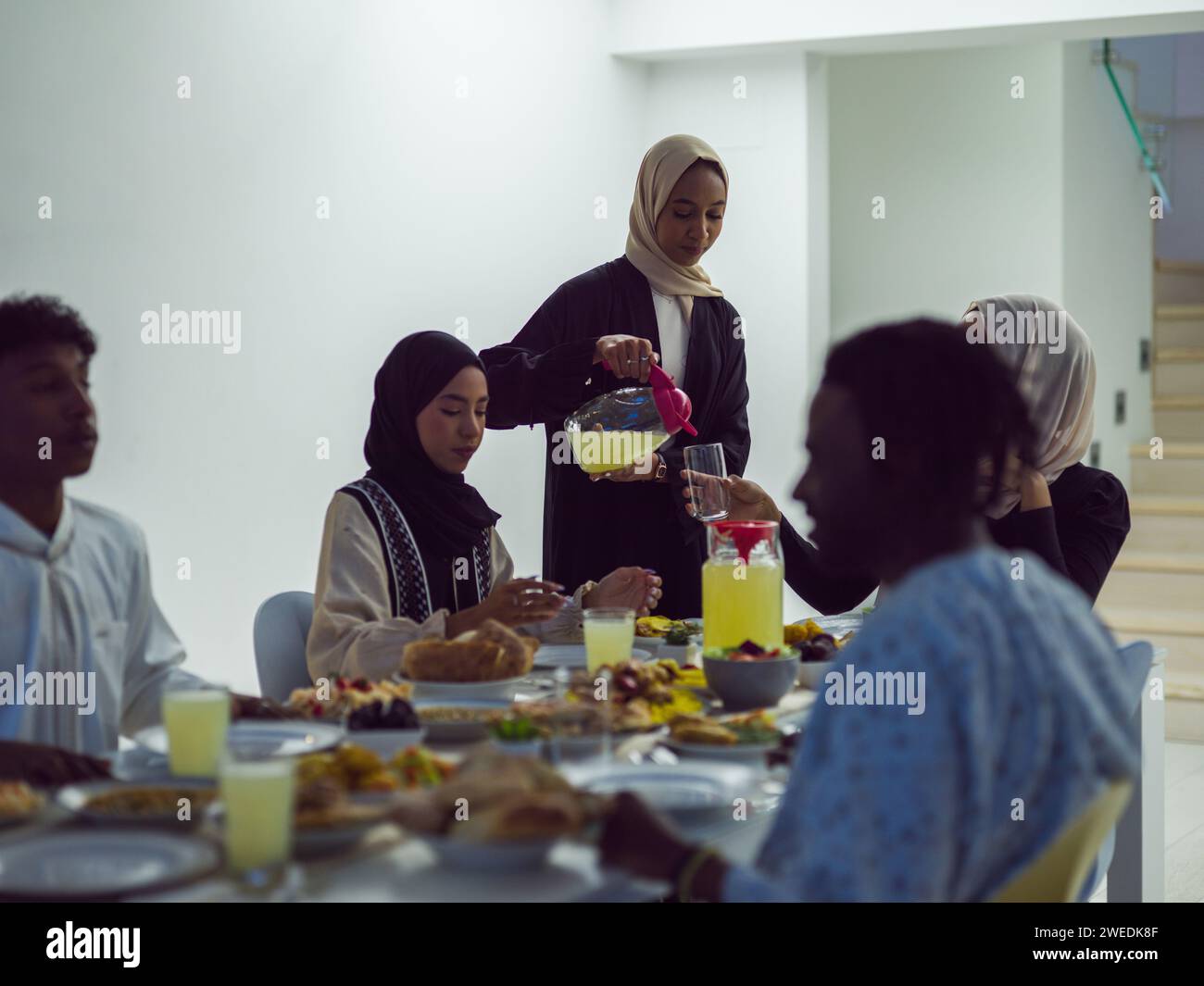 A diverse Islamic family gathers for iftar, joyfully breaking their ...