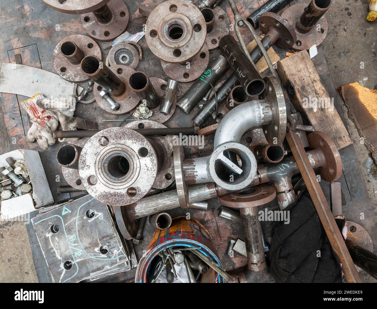 Discarded machine parts on the floor of an industrial workshop Stock ...