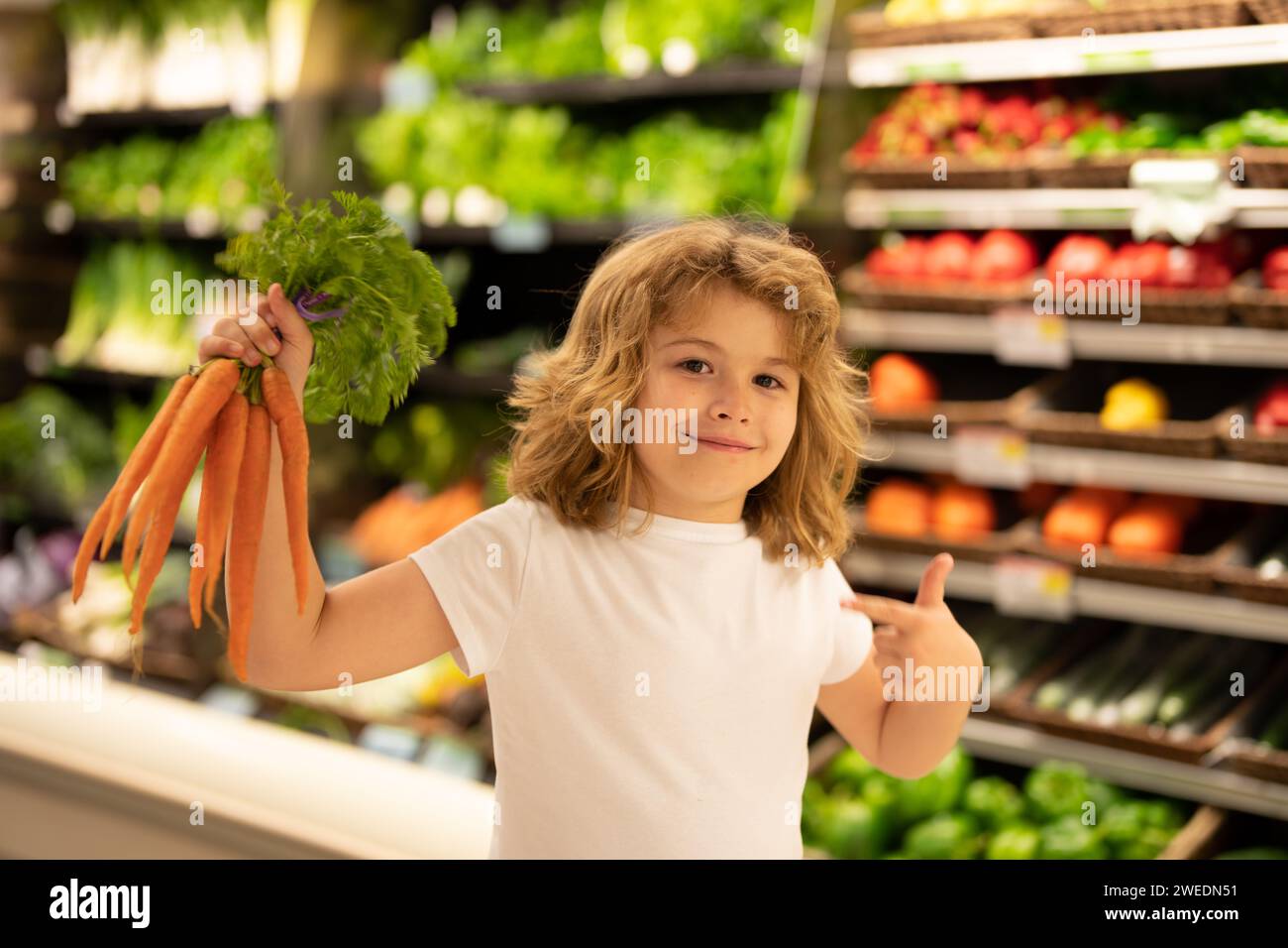 Child choosing vegetables in supermarket store. Kids in food ...