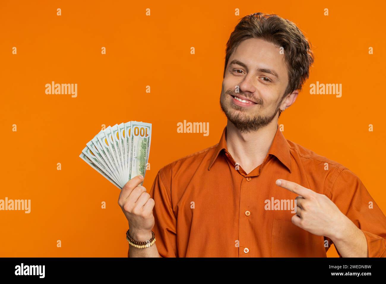 Rich pleased happy Caucasian man pointing finger on money dollar cash ...