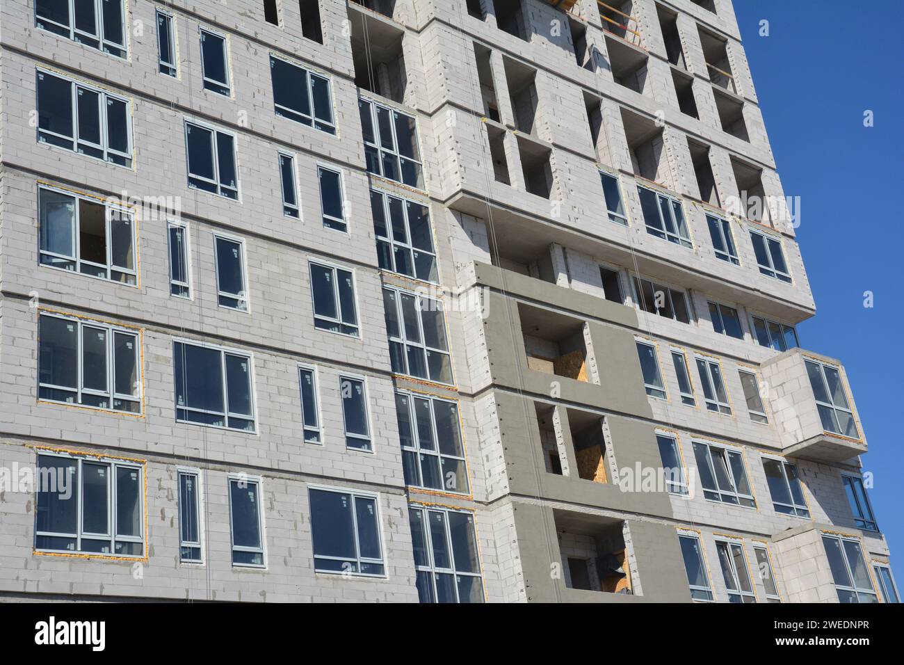 A new residential building construction with incomplete exterior works ...