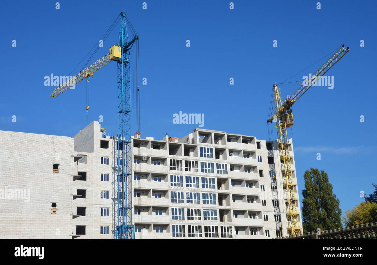Two tower cranes are erecting a high rise building, residential ...