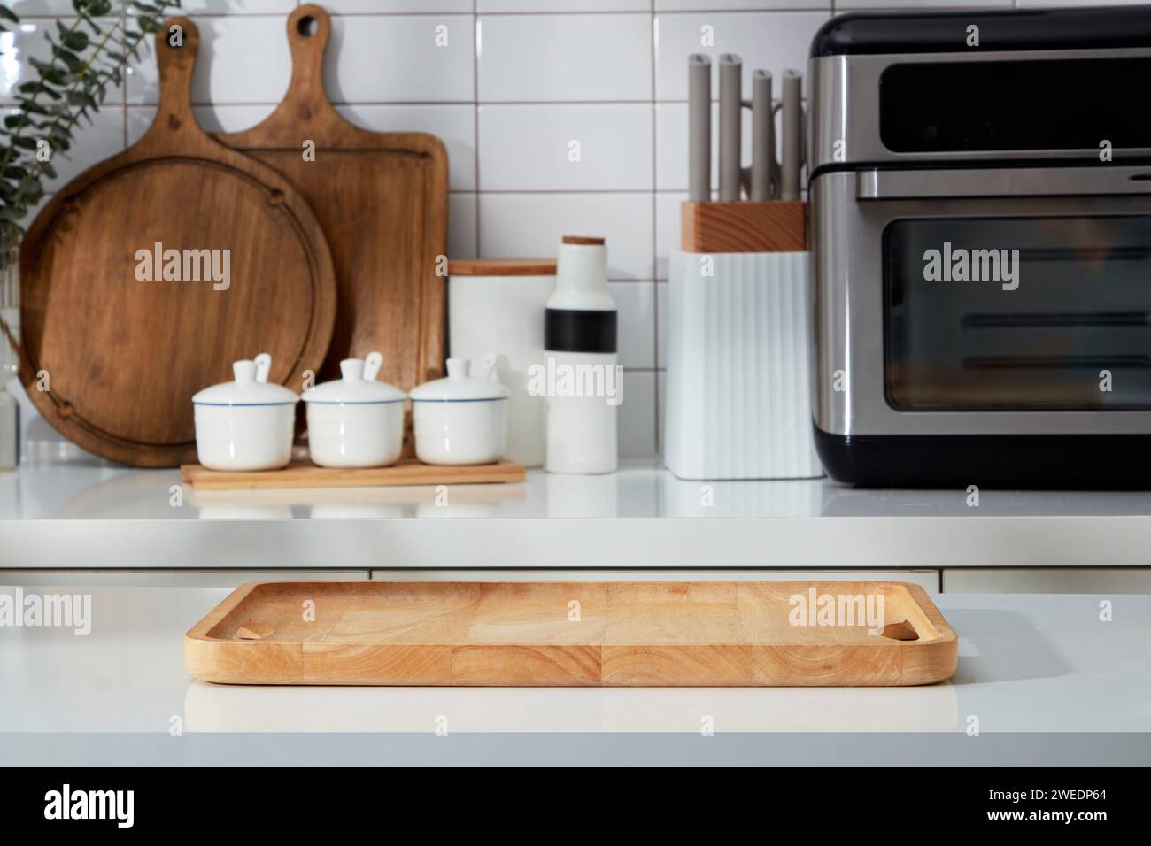 Modern kitchen interior with full appliances - wooden cutting board ...