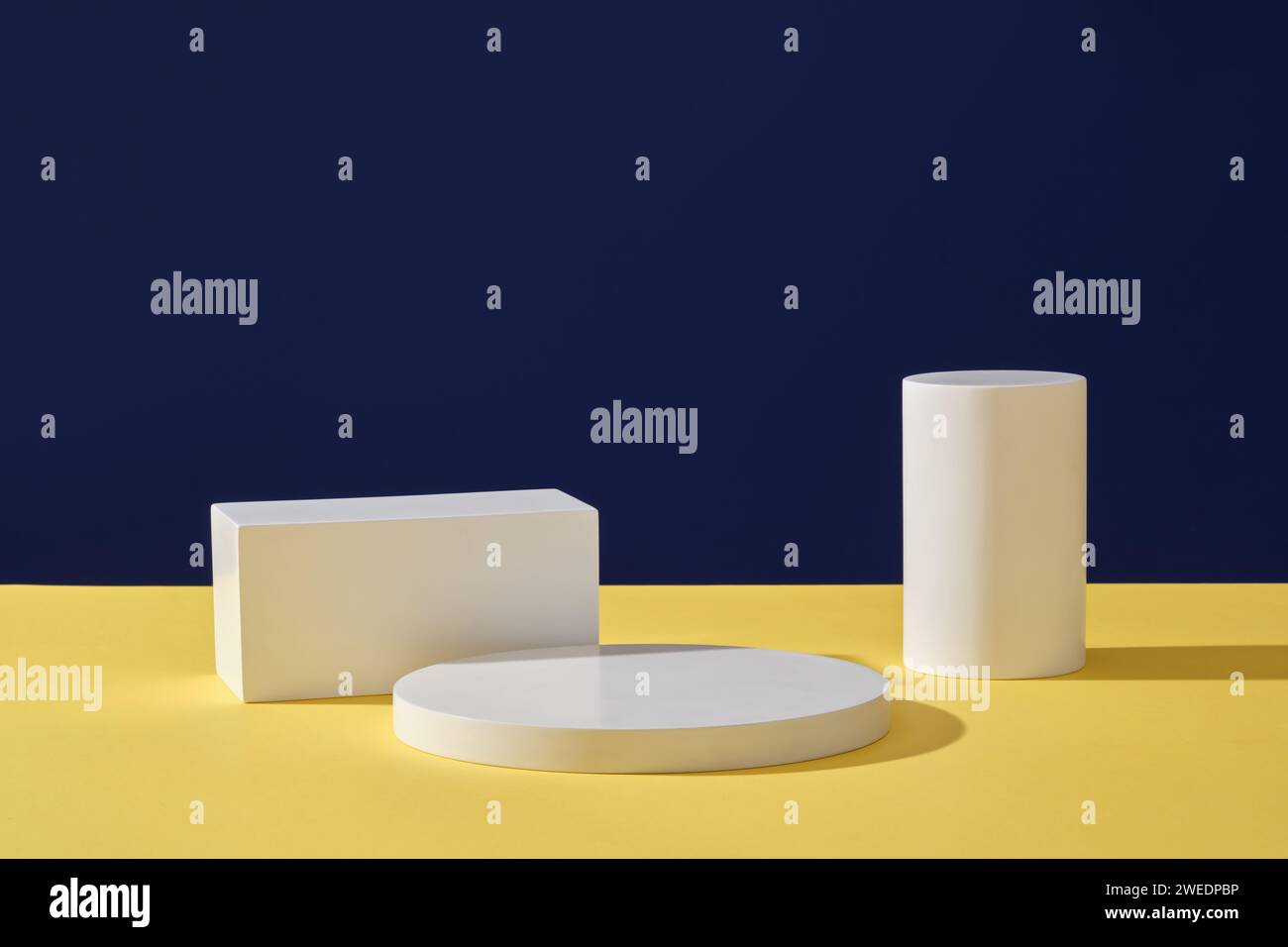 Front view of round and rectangular white empty platforms arranged on a ...