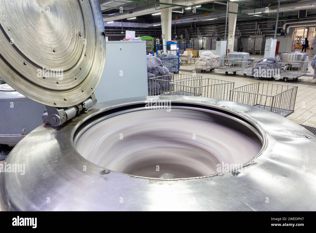A hydraulic extractor squeezes out excess moisture from textile ...