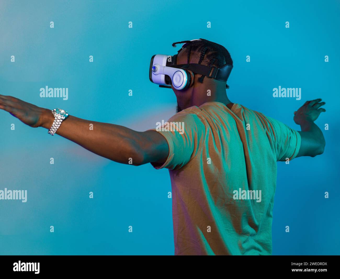 African American man dons VR glasses, engrossed in a virtual reality ...