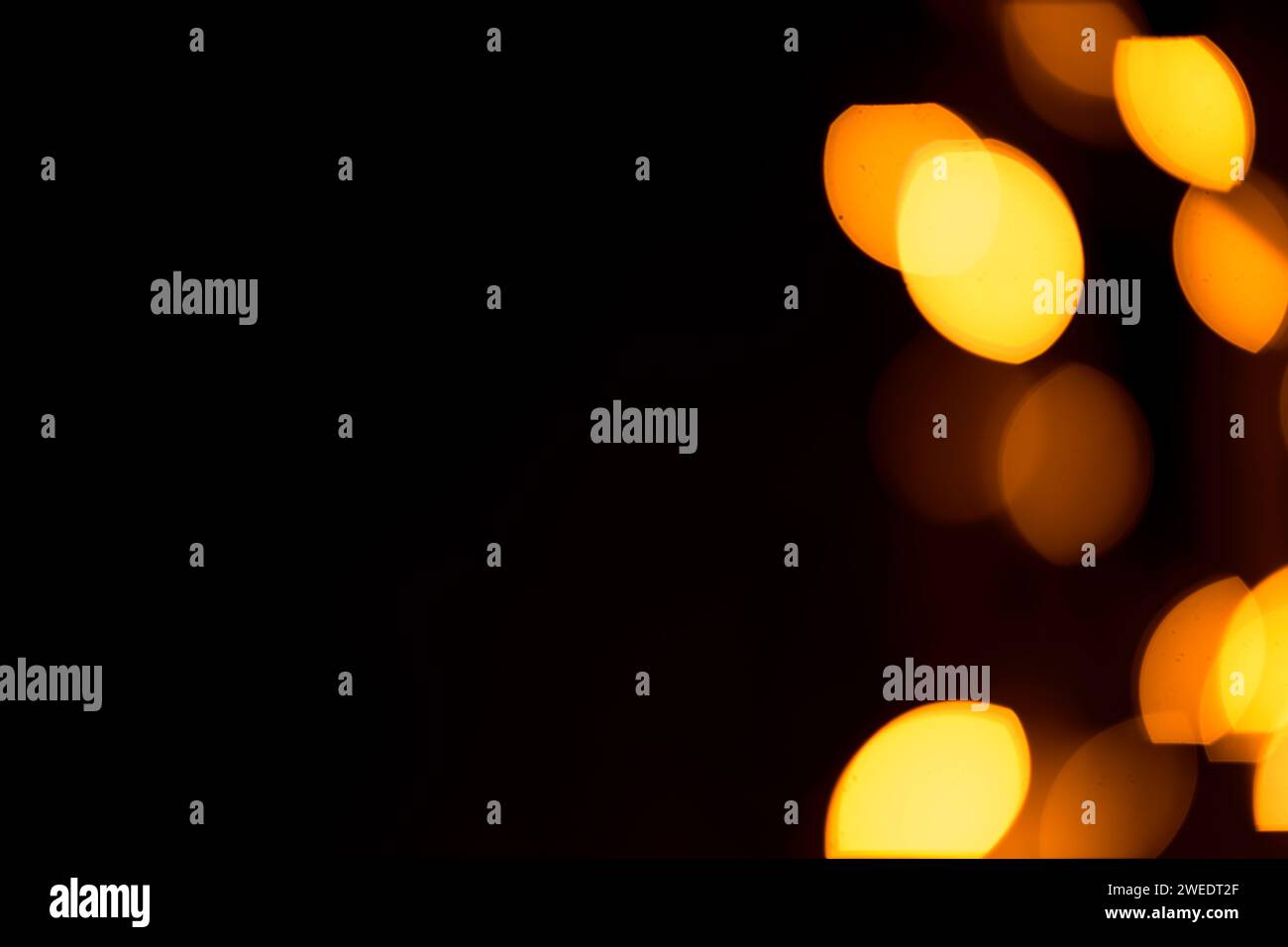 Bright yellow, gold lights, bokeh on black background. festive texture ...