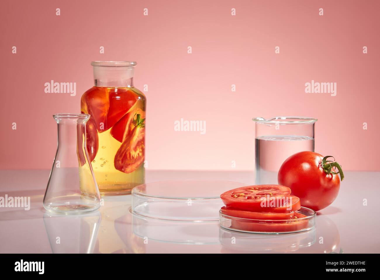 Lab theme with lab glassware containing essence of tomato and fresh ...