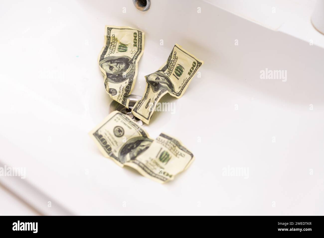Cash Money Going Down Sink Drain Isolated on White Background Stock ...