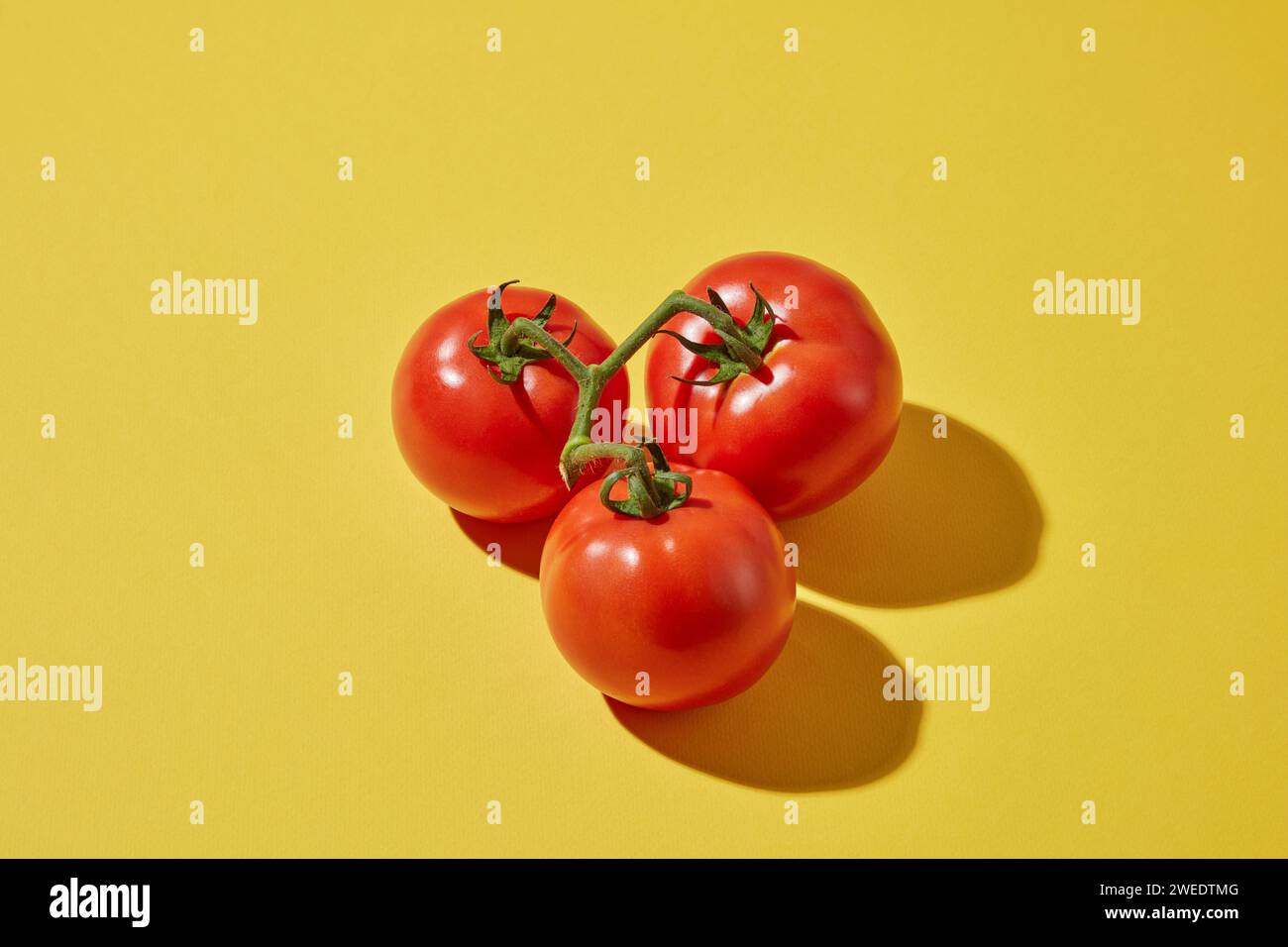 Minimal scene with fruit - top view of three ripe fresh tomatoes with ...
