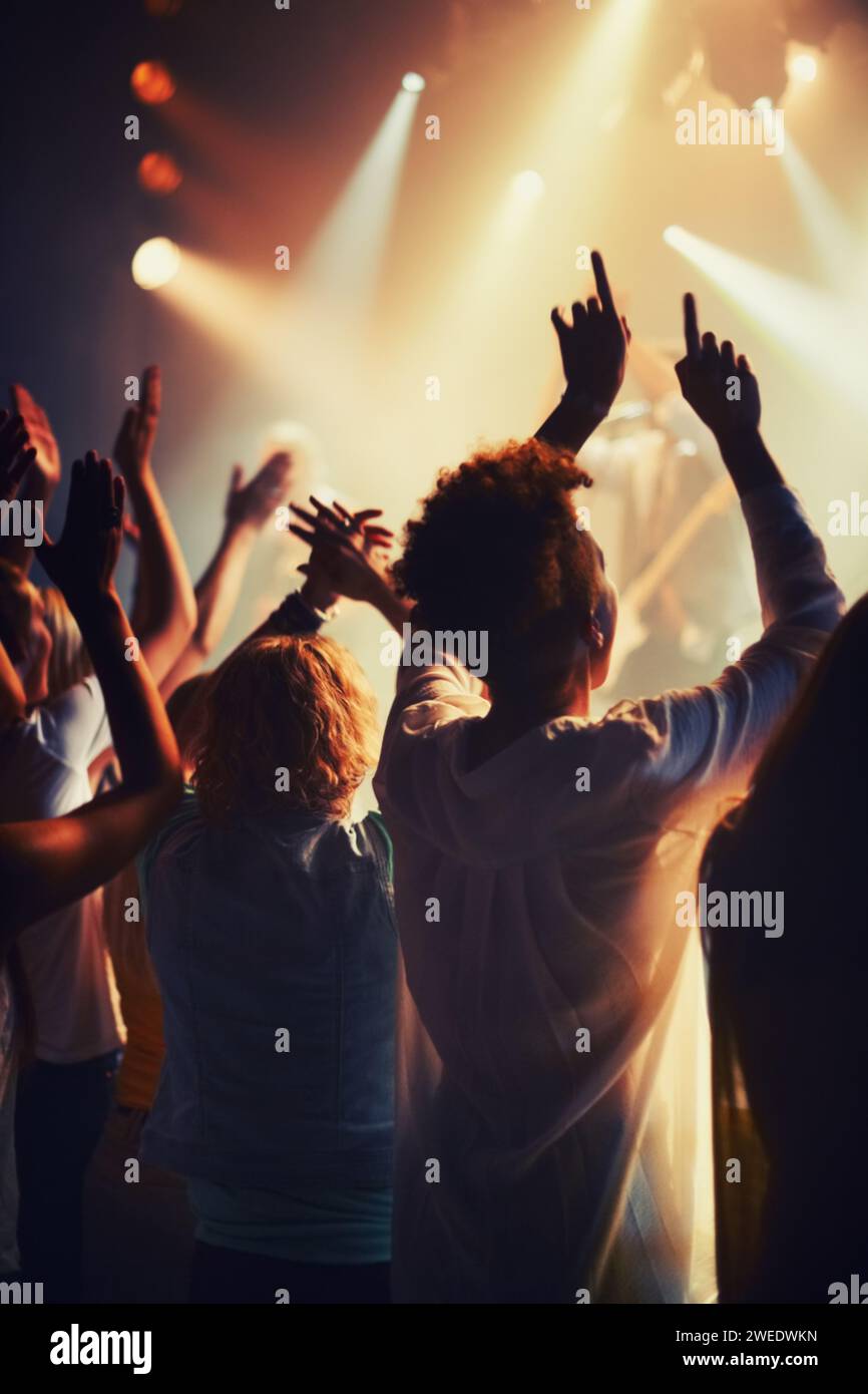 Concert, fans and people dance to music, event and lights on stage for ...