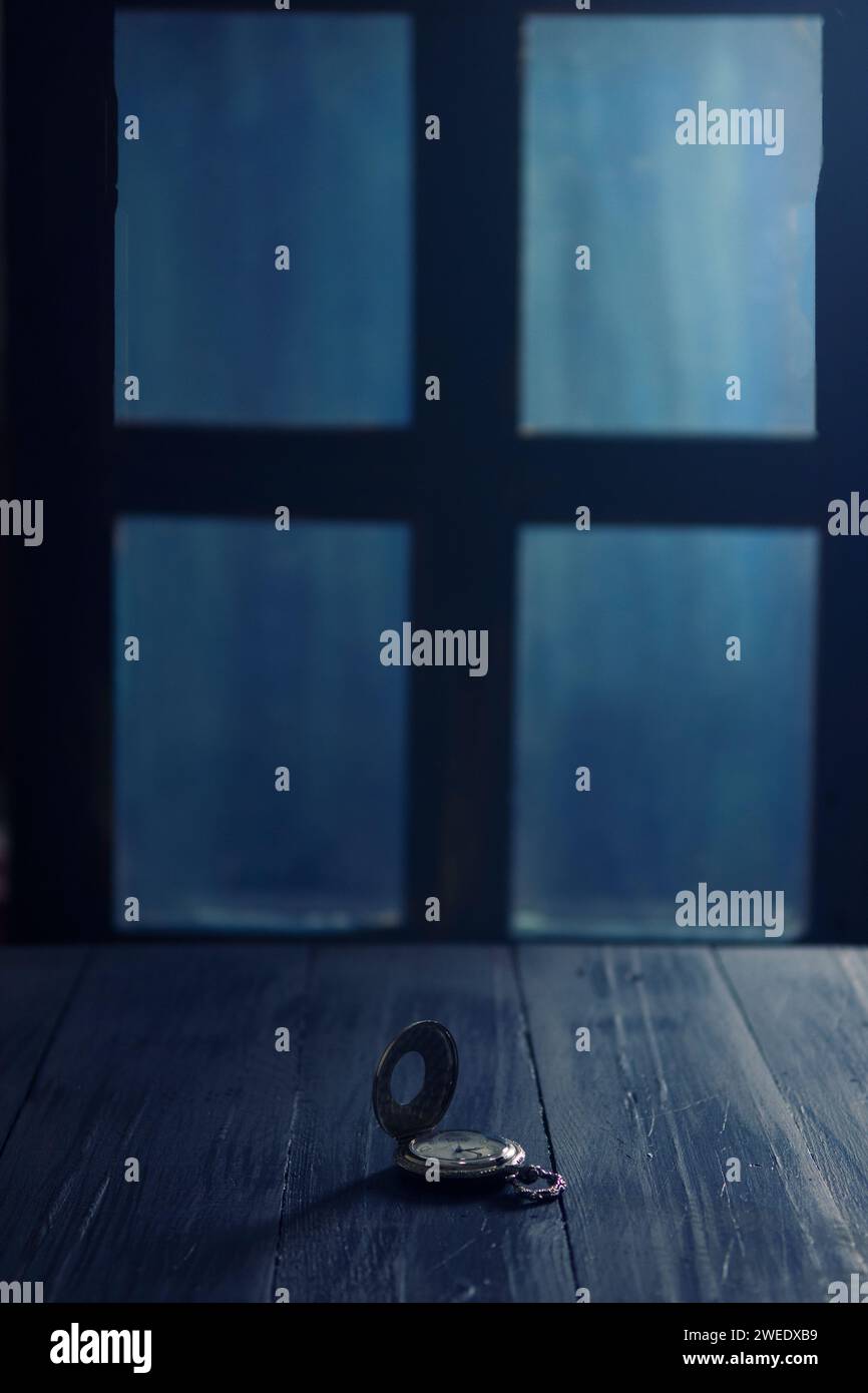 Old pocket watch by the window at night Stock Photo - Alamy