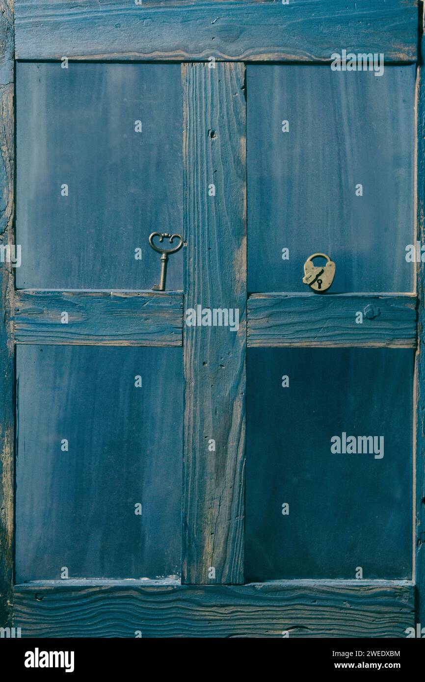 old fashioned padlock and key by the window Stock Photo - Alamy