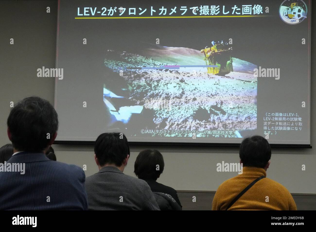 Journalists watch an image taken by Lunar Excursion Vehicle 2 (LEV-2 ...