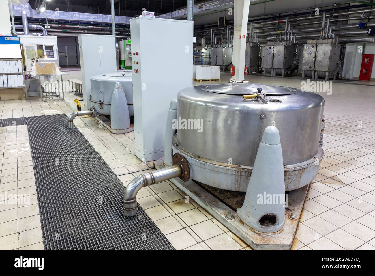 A hydraulic extractor loaded with bags of women's tights. The extractor ...