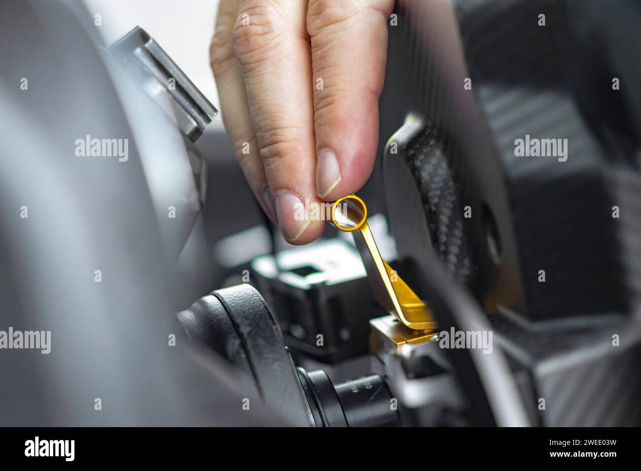 Releasing safety lock on a racing car steering wheel Stock Photo - Alamy