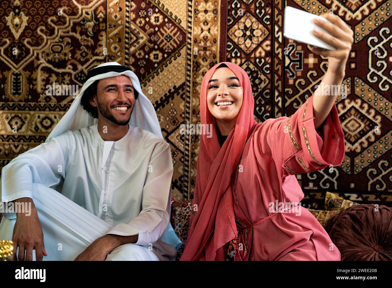Young couple from Emirati spending time in an arabian traditional cafe ...