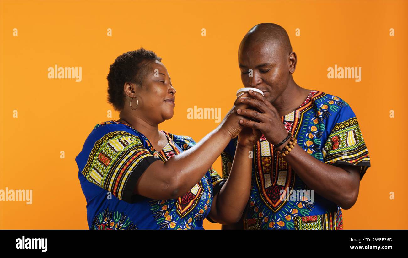 Ethnic couple enjoying aroma of fresh coffee drink, smelling caffeine ...