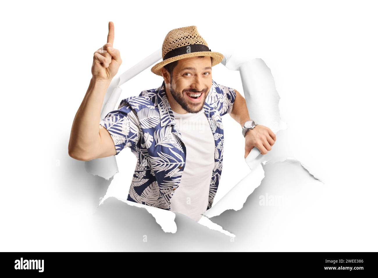 Man peeking through a paper hole and pointing up isolated on white ...
