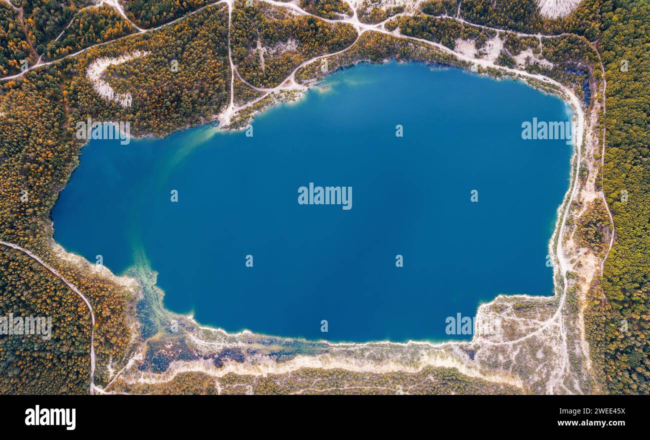 Emerald lake in a flooded quarry in the forest from a bird's eye view ...