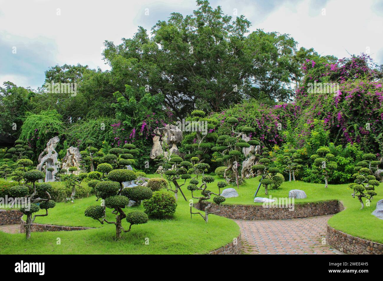 Beautiful landscape of a botanical garden with trimmed trees with ...