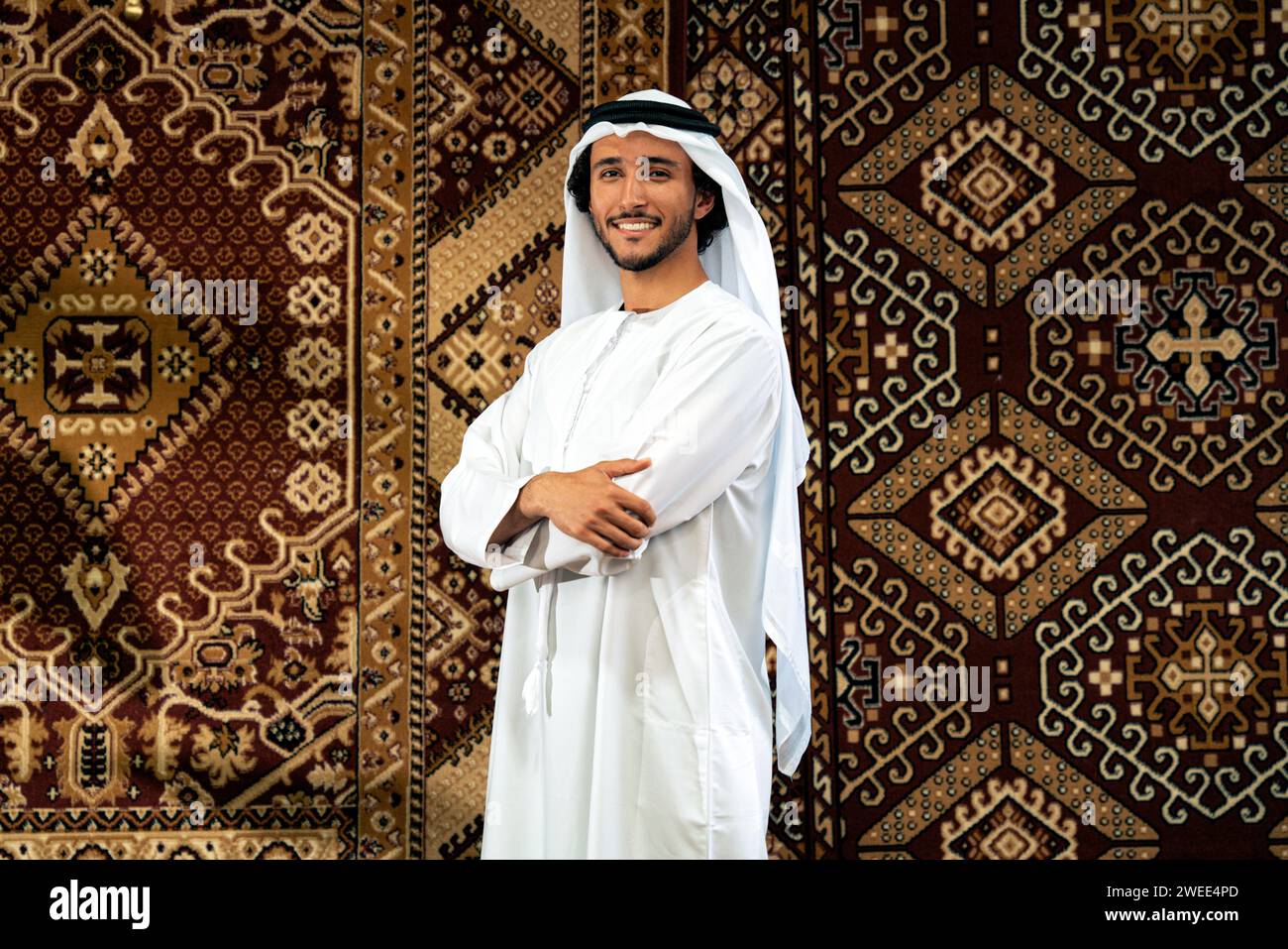 Man from emirati wearing kandura outfit spending time in an arabian ...