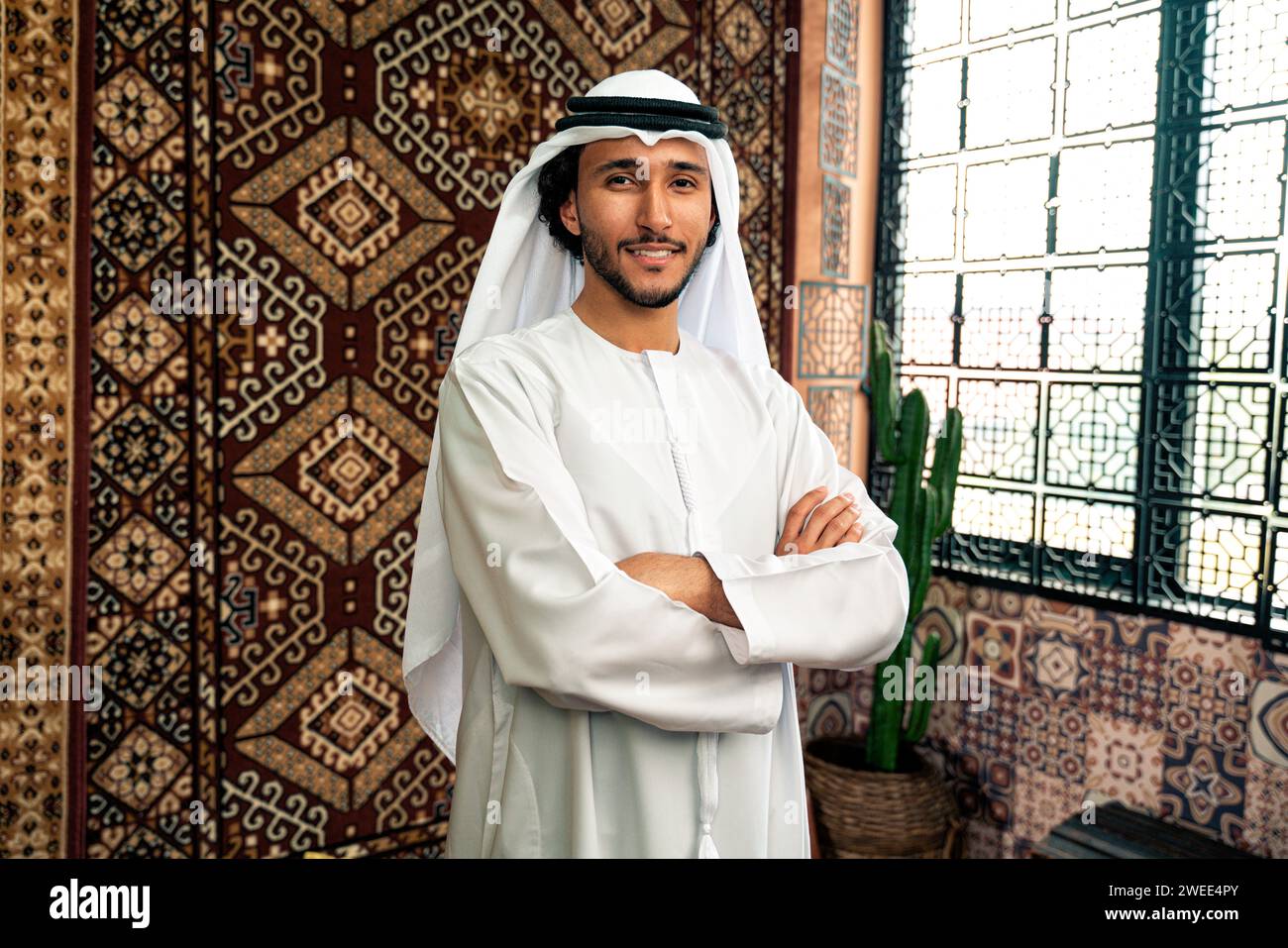 Man from emirati wearing kandura outfit spending time in an arabian ...
